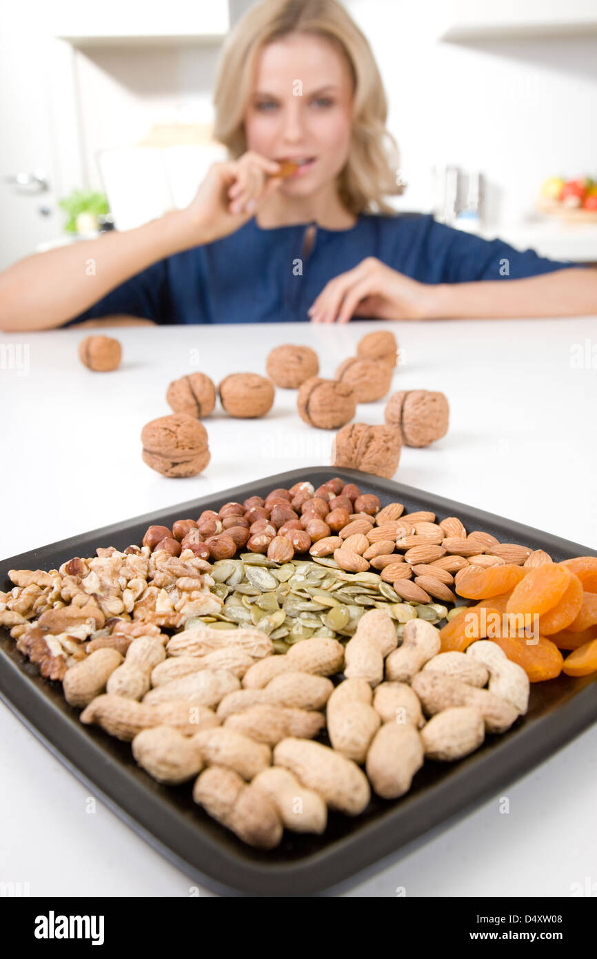Woman eating nuts hi-res stock photography and images - Alamy