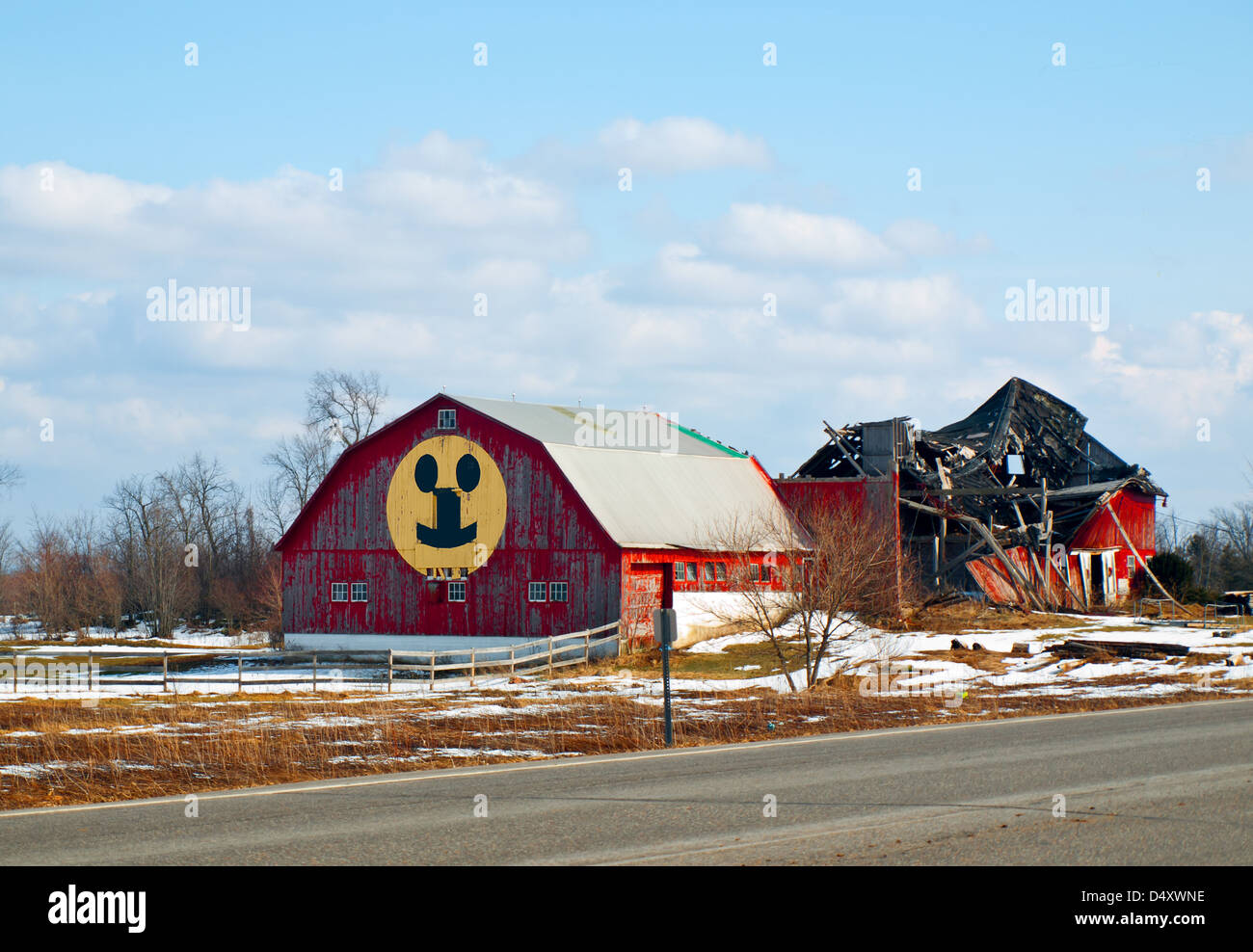 barn with smiley face next to collapsed barn structure Stock Photo - Alamy