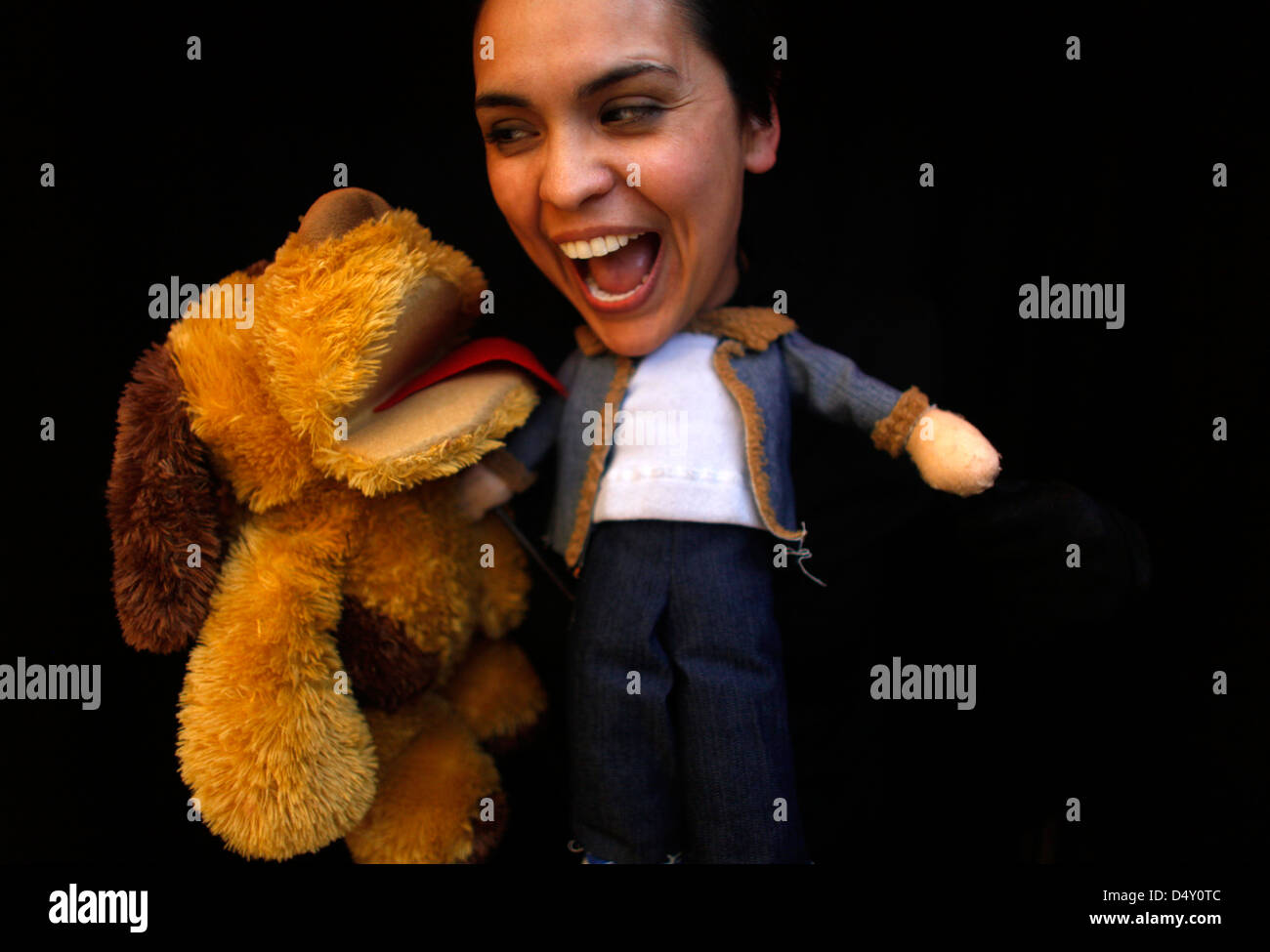 An actress dressed as a boy performs using a teddy bear dog during a ...
