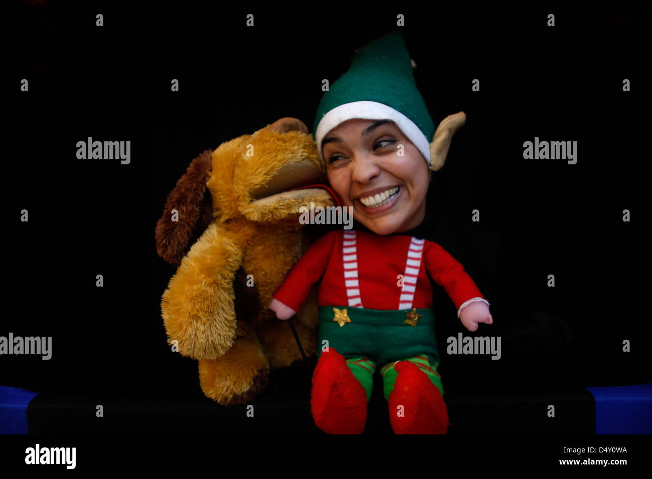 An actress dressed as a leprechaun performs using a teddy bear dog ...