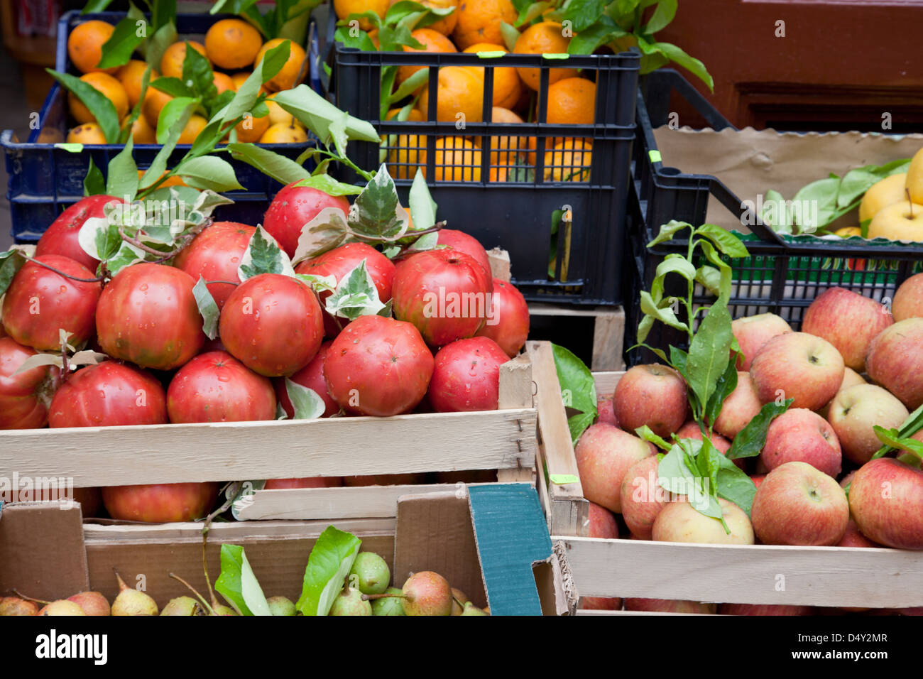 Close up of fresh fruit displayed in crates outside a grocery store in ...