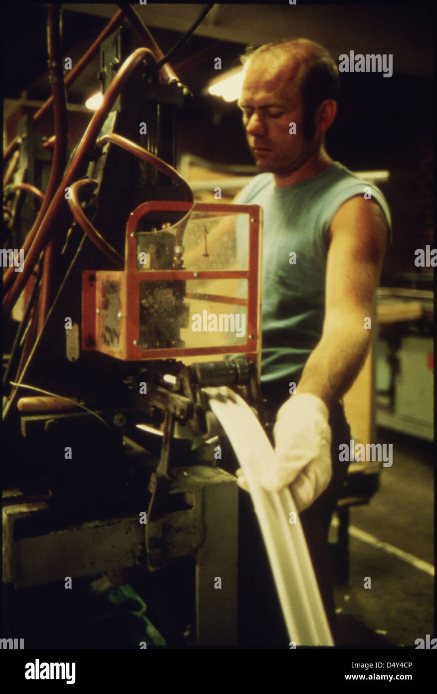 Employee of the B.F. Goodrich Co., Working on a Machine That Makes ...