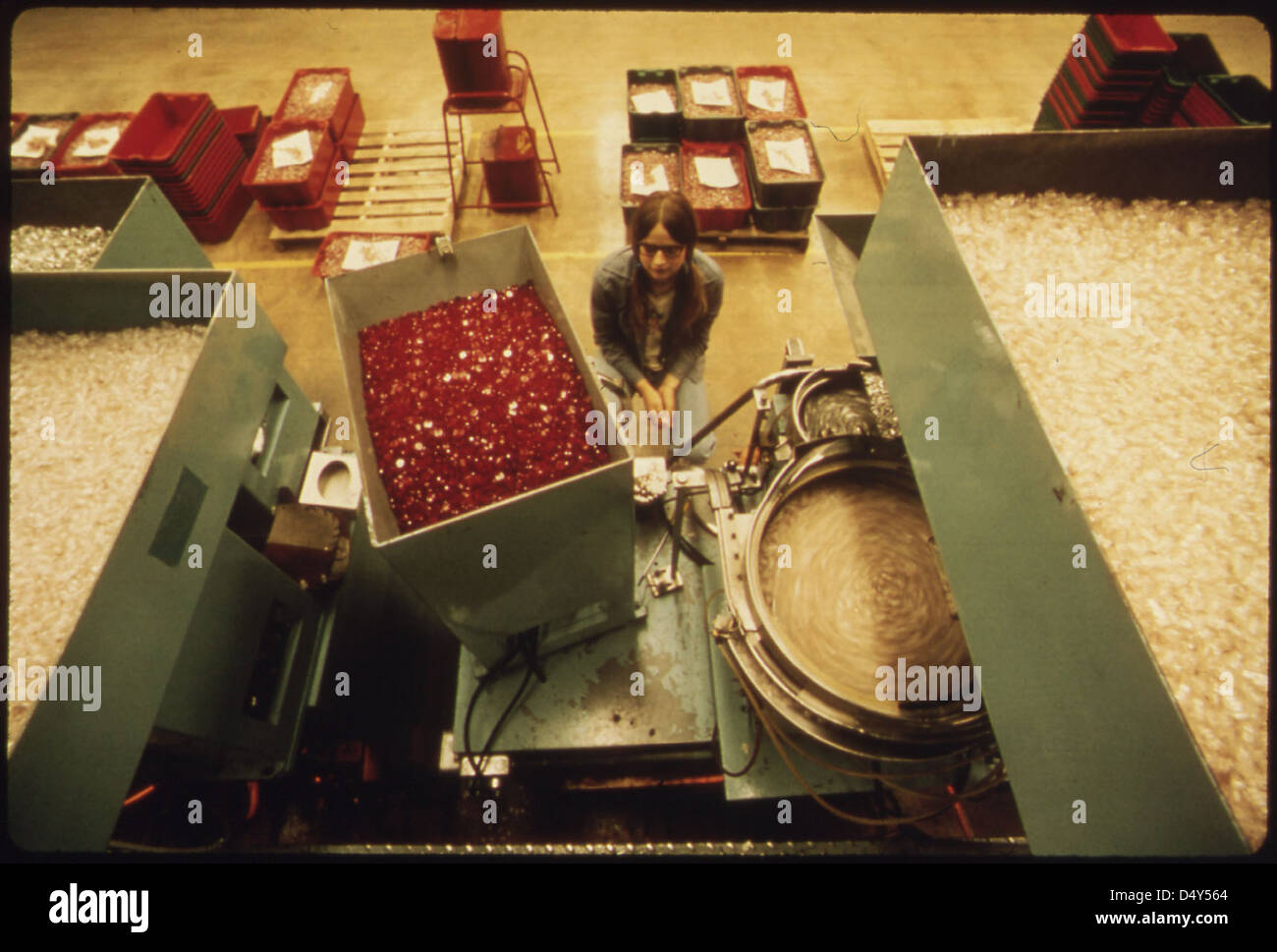 A photograph of an employee monitoring a machine inside the 3M Co ...
