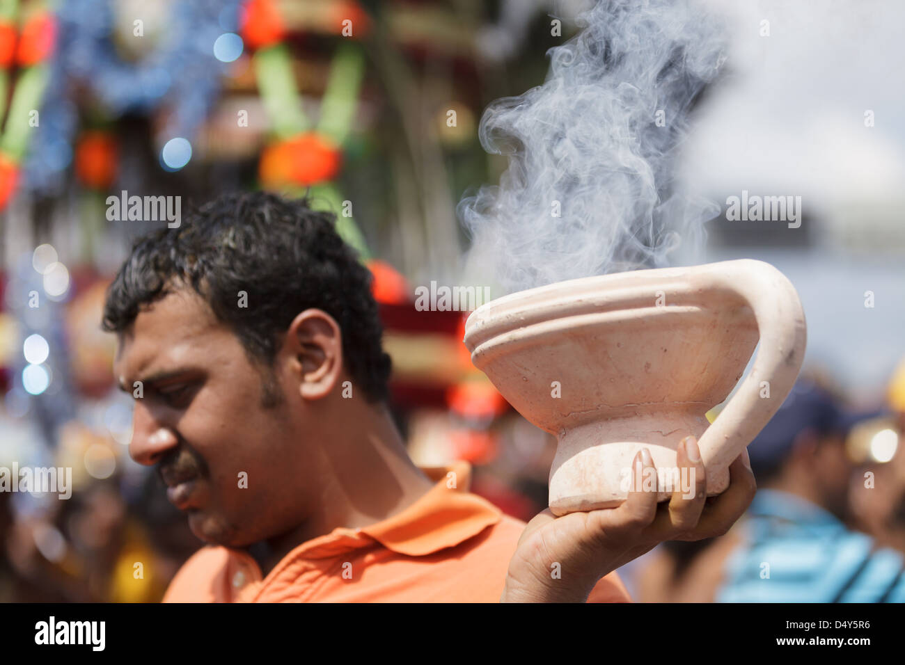 Hindu devotee holding incense burning pot in annual Thaipusam religious ...