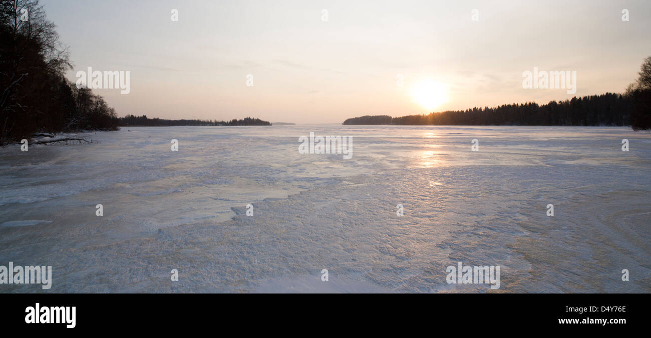 View of frozen lake at sunset , Finland Stock Photo - Alamy