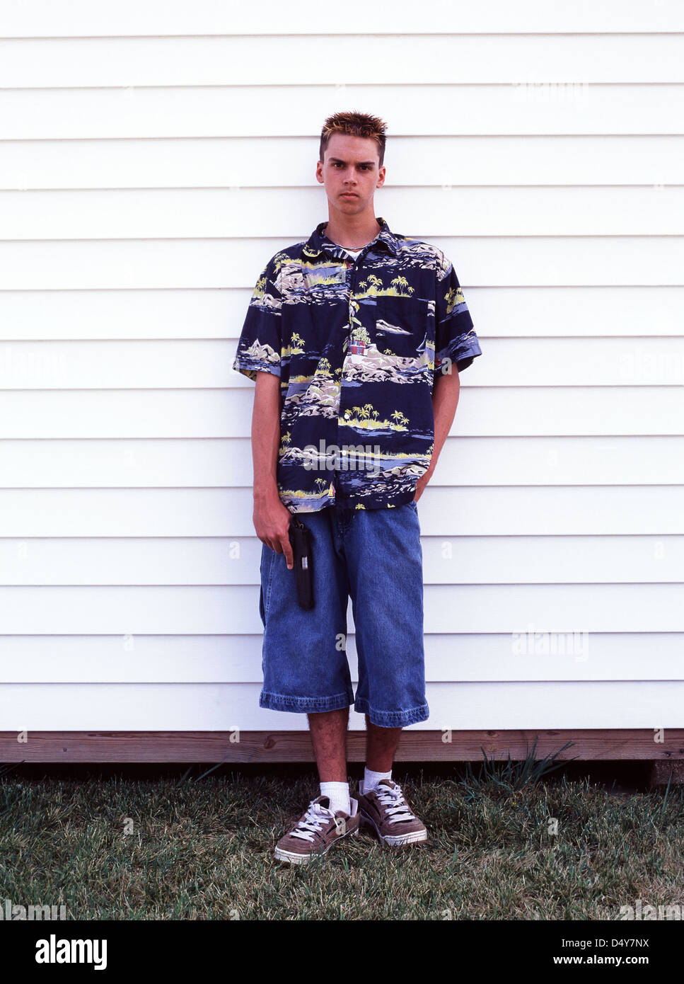 A young man holds his gun and faces the camera Stock Photo - Alamy