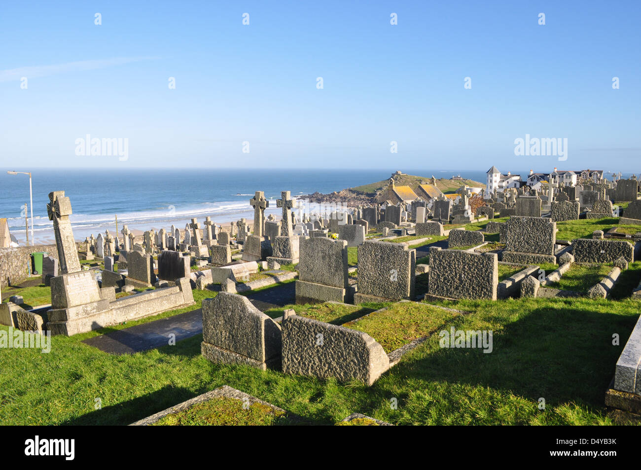 Graves at Barnoon Cemetery St. Ives Cornwall, England with sea and blue ...