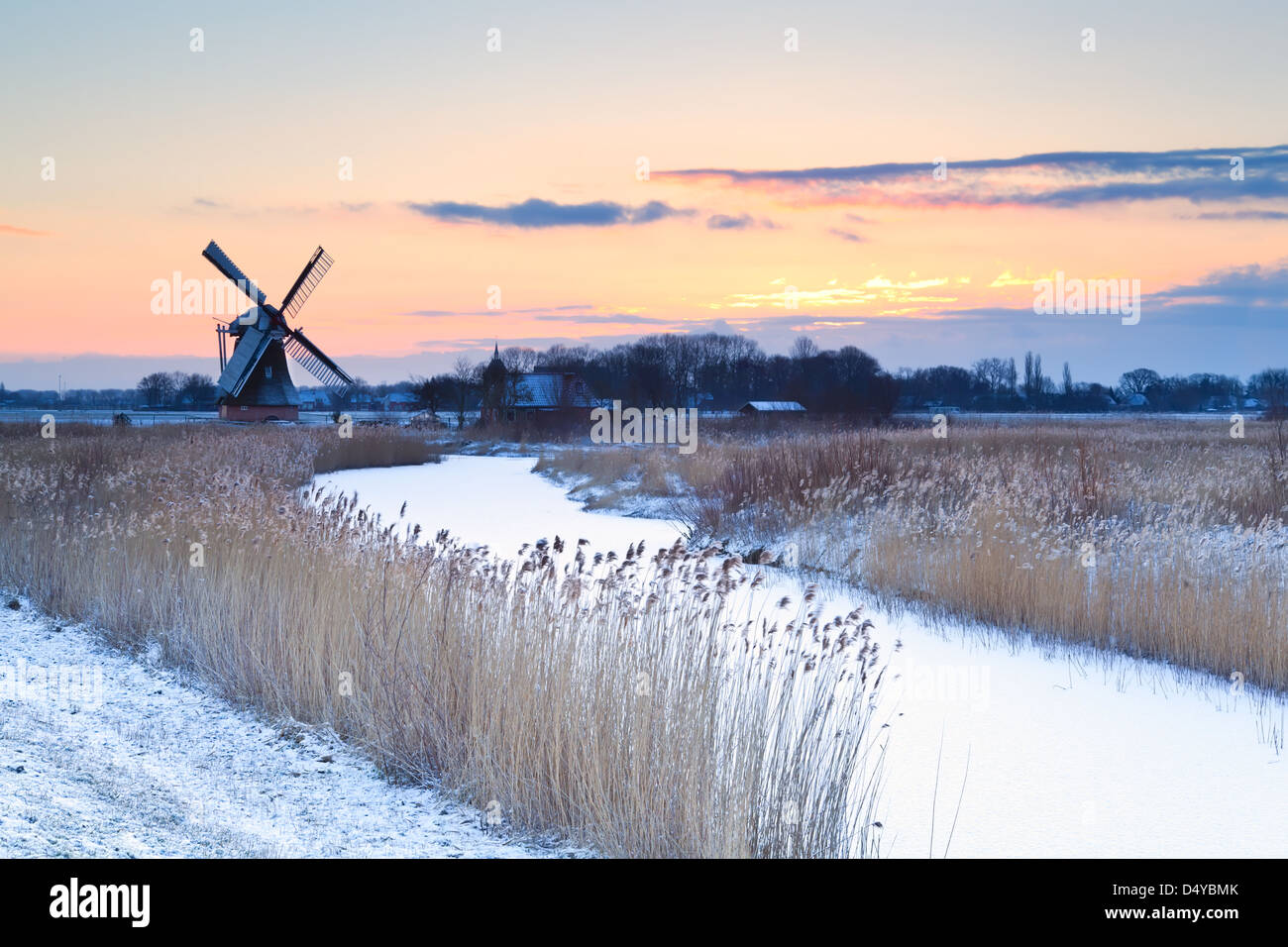 Dutch windmill in winter at sunrise, Groningen Stock Photo - Alamy