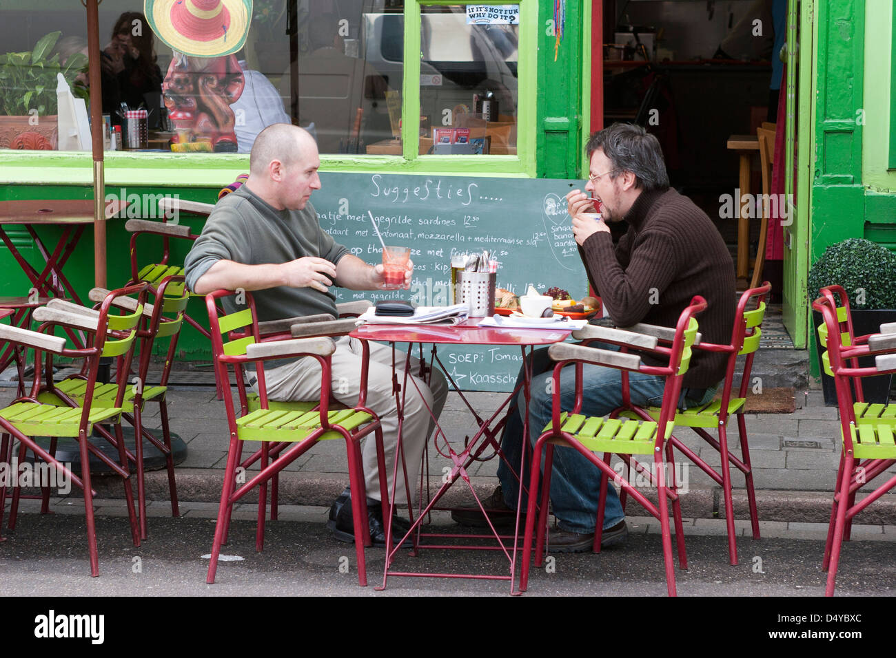 Two Men eating outside Cafe in Antwerp Stock Photo - Alamy