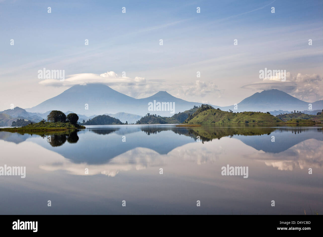 Lake Mutanda near Kisoro with the Virunga Volcanoes as reflection in ...
