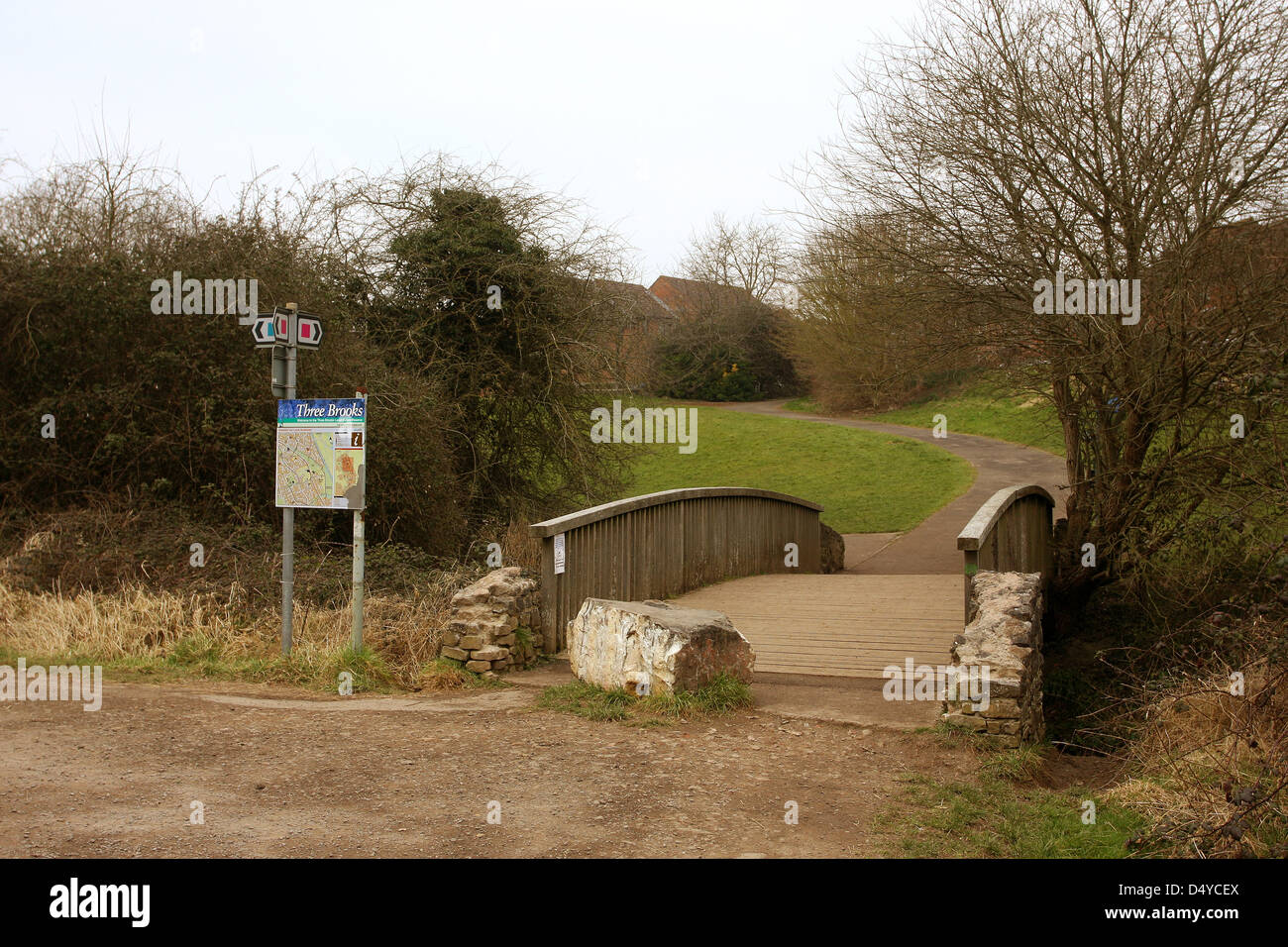 Small bridge crossing into a park, large rock to stop vehicles using ...