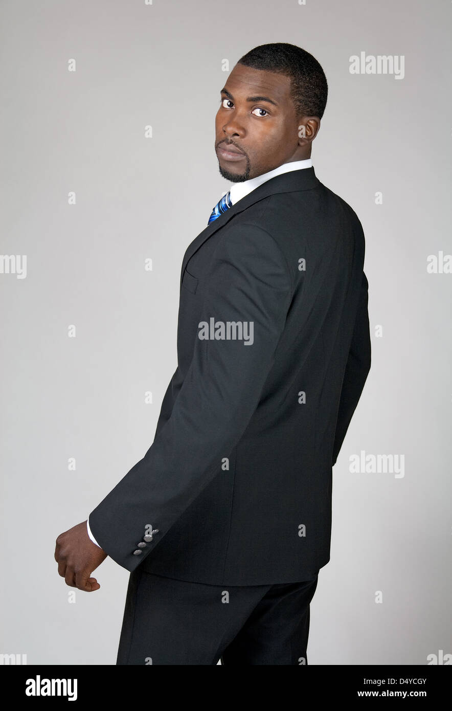 African American businessman turning and looking back Stock Photo - Alamy
