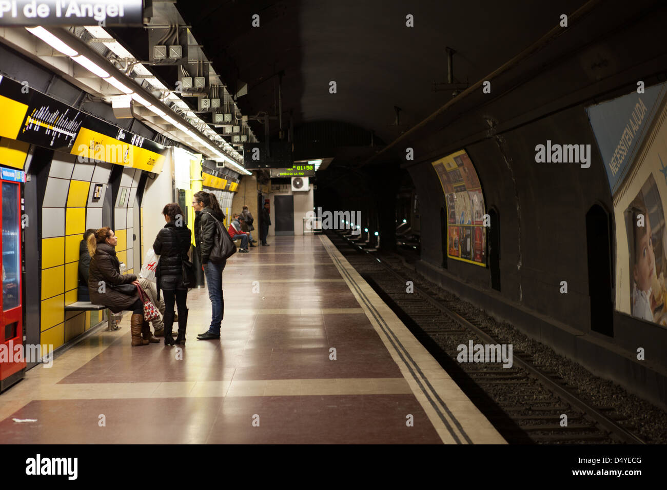 Passengers await the arrival of a train. Barcelona Metro. The city ...