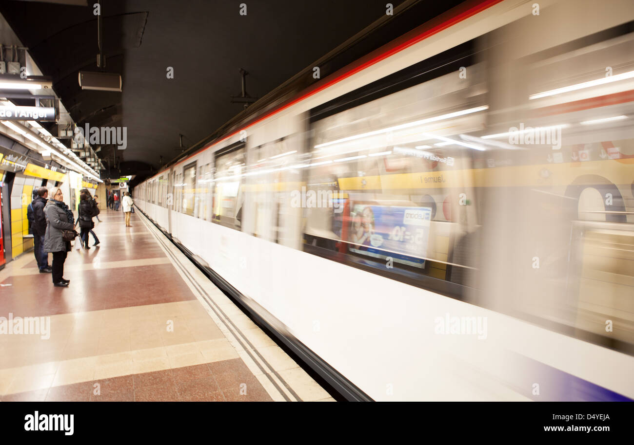 Passengers await the arrival of a train. Barcelona Metro. The city ...