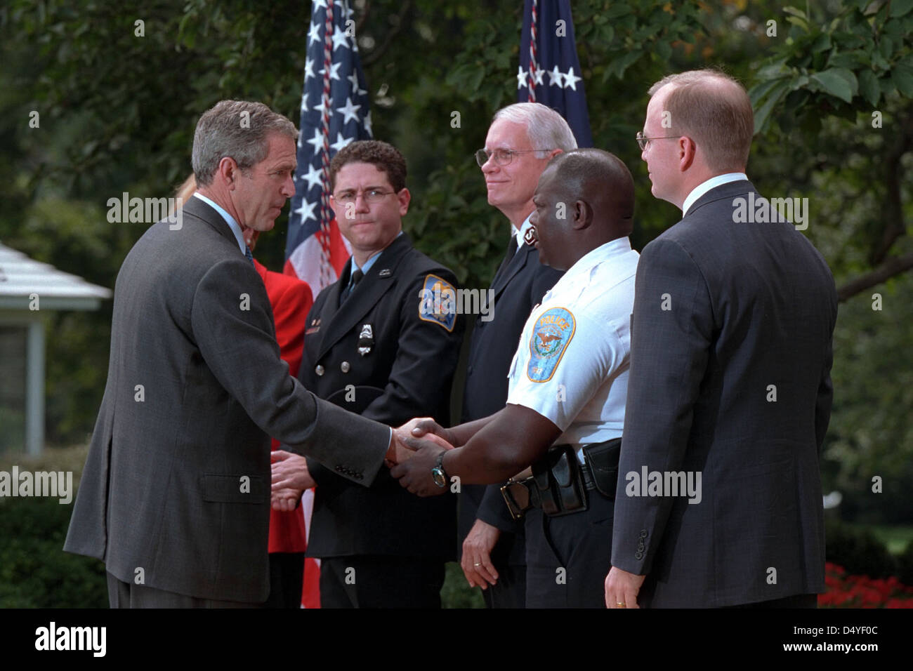 President George W. Bush shakes hands with a police officer Tuesday ...