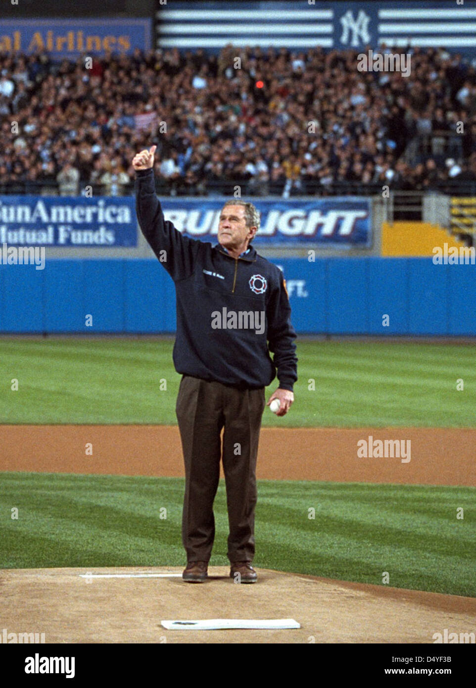 President George W. Bush gives a thumbs-up before throwing the ...