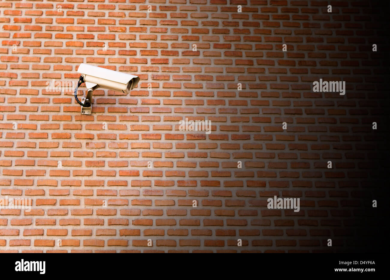 Surveillance camera on a brick wall Stock Photo - Alamy