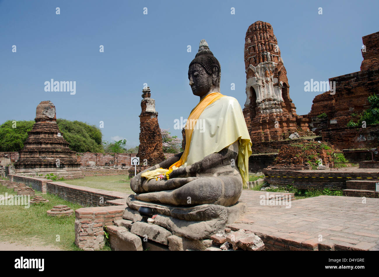 Thailand, Ayutthaya. Wat Mahathat (aka Wat Maha That). UNESCO. Buddha statue in yellow robe with ...