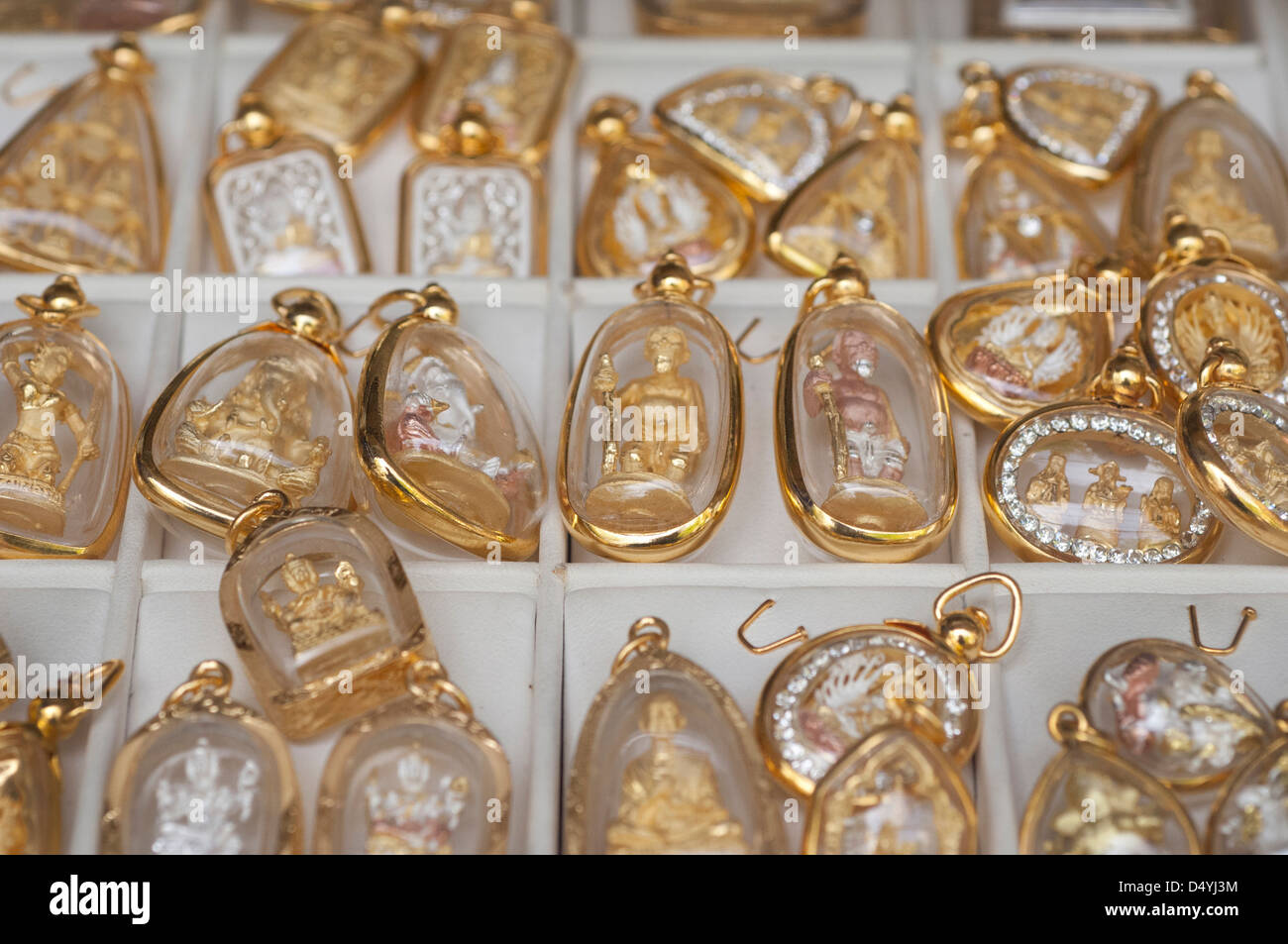 Thailand, Bangkok Amulet Market. Detail of golden amulets, worn around ...