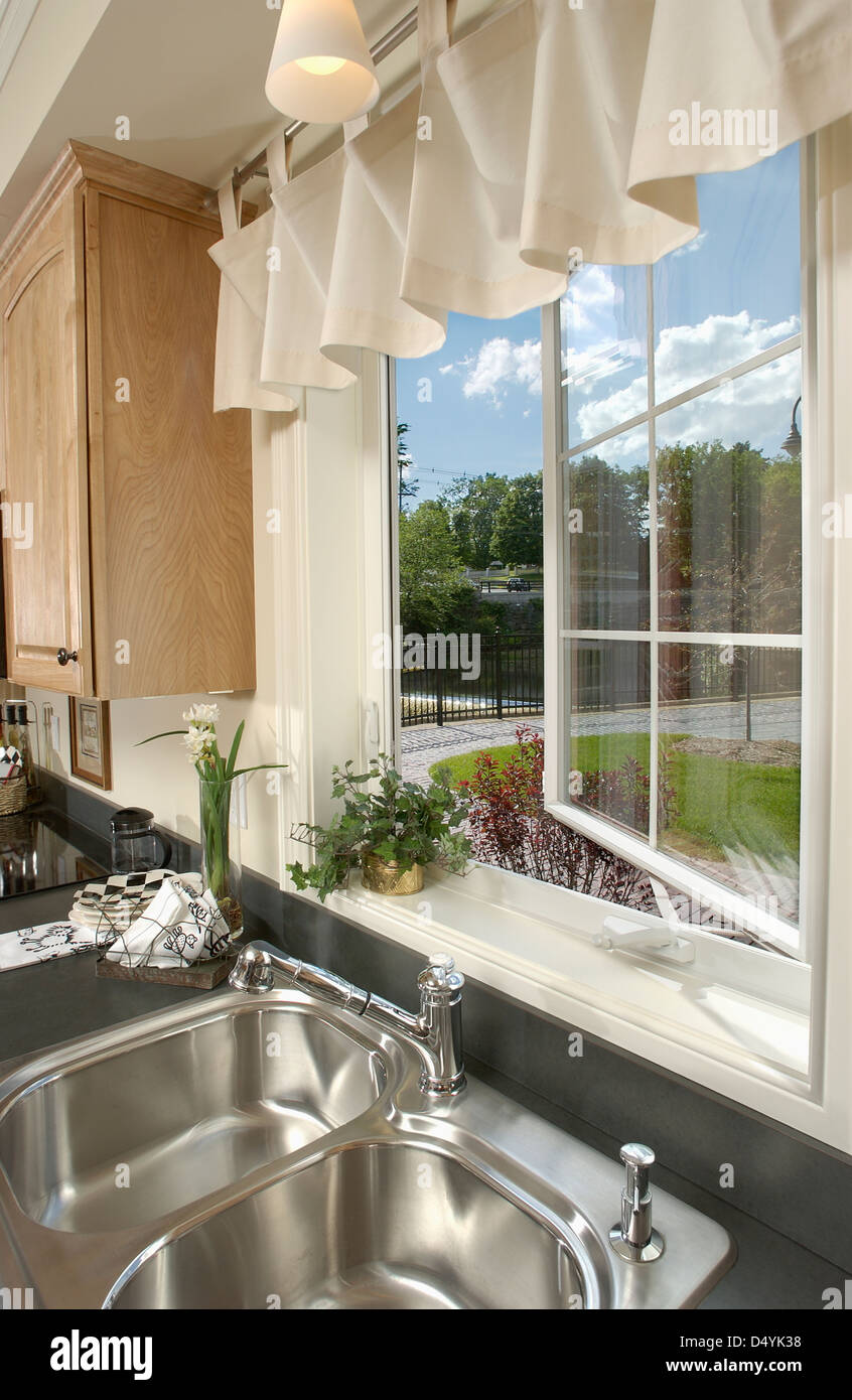 Sinks on countertop by window in kitchen Stock Photo - Alamy