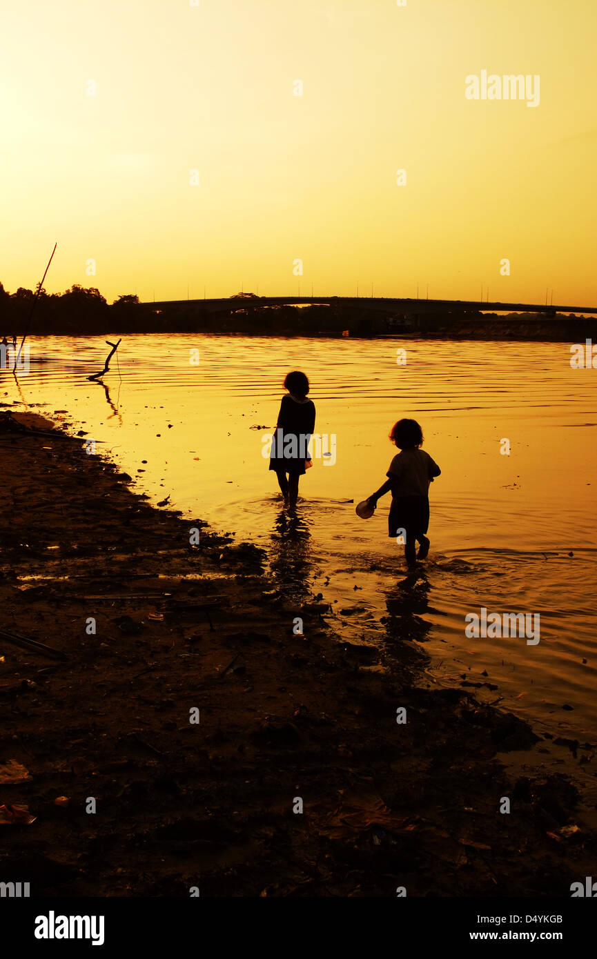 two young girls were walking through the river Stock Photo - Alamy