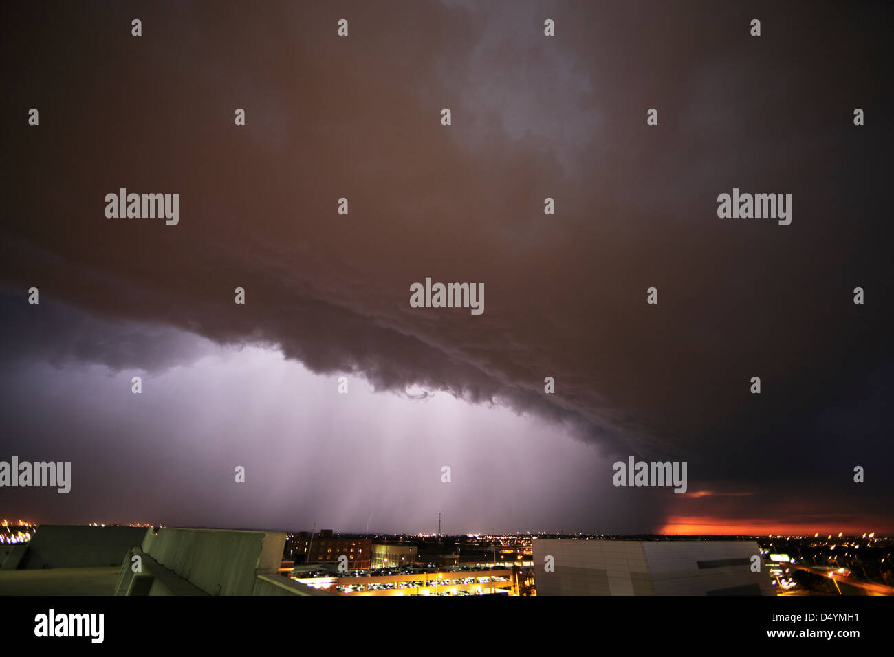 Large nighttime storm, lit by lightning above city Stock Photo - Alamy