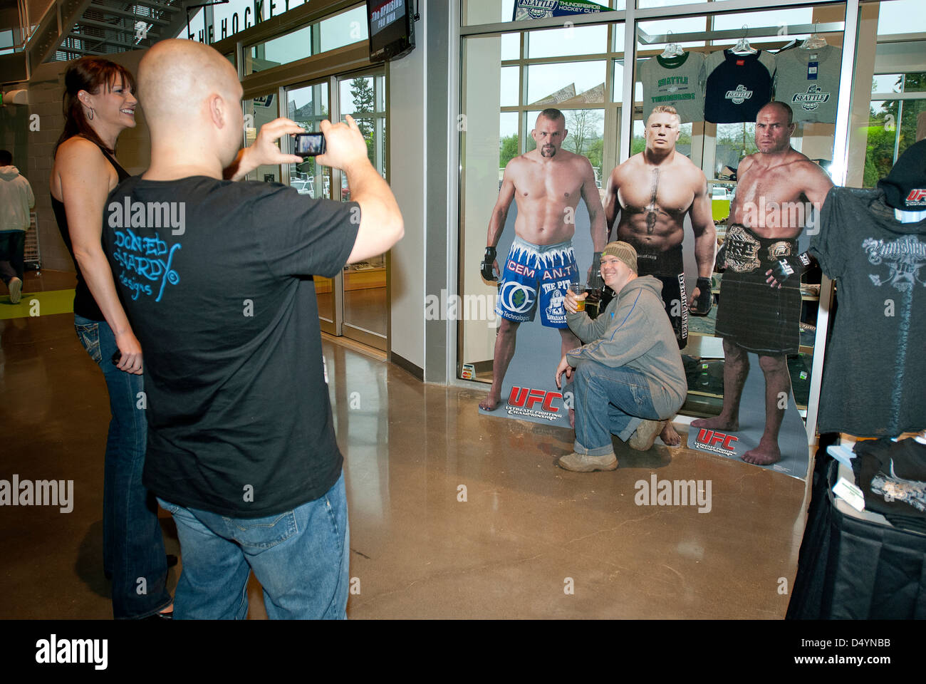 Fans posing in front of UFC life-sized cardboard stand Stock Photo - Alamy