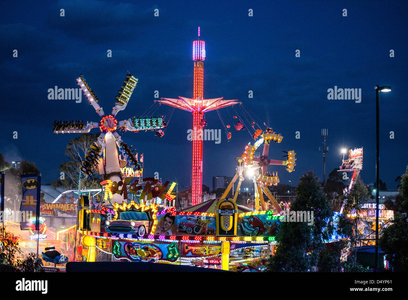 All the fun of the fair. A night time view of the colorful rides at the ...