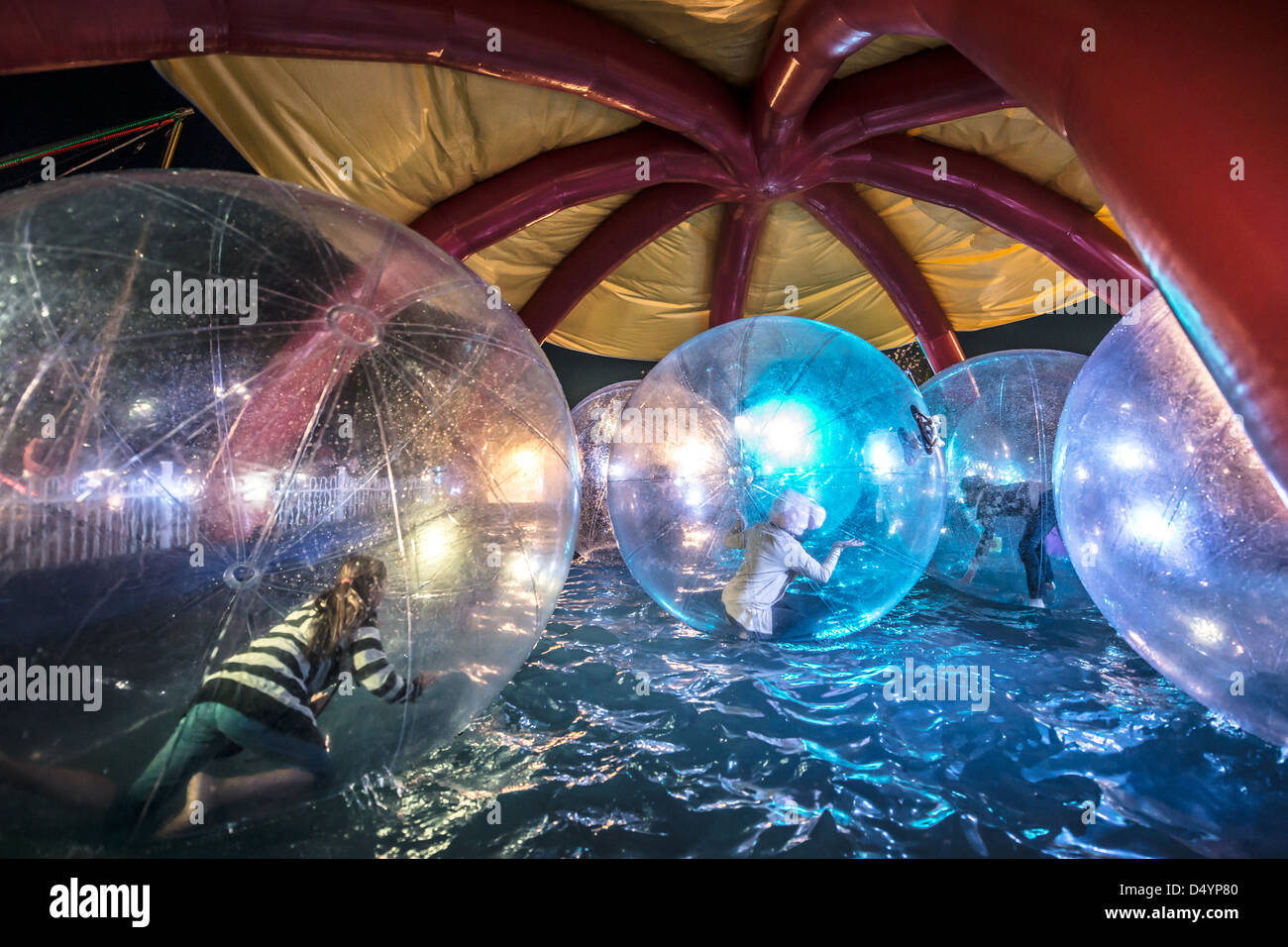 All the fun of the fair. A night time view of the colorful rides at the ...
