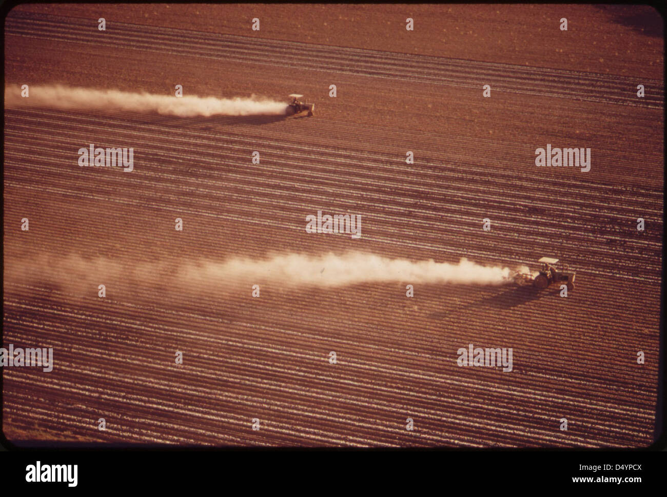 This May 1972 photograph captures the process of fertilizing crops as ...