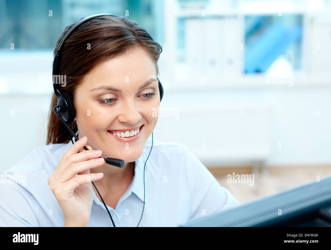 Portrait of young operator with headset consulting clients online Stock ...
