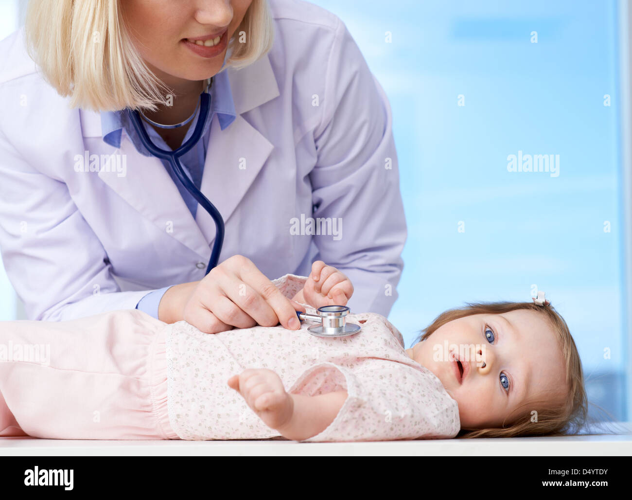 Female pediatrician taking care of cute baby in hospital Stock Photo ...