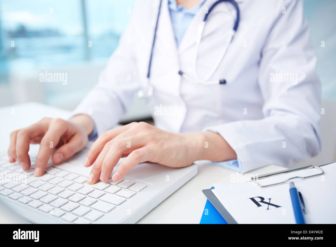 Modern medical person inputting diagnosis into an online data base ...