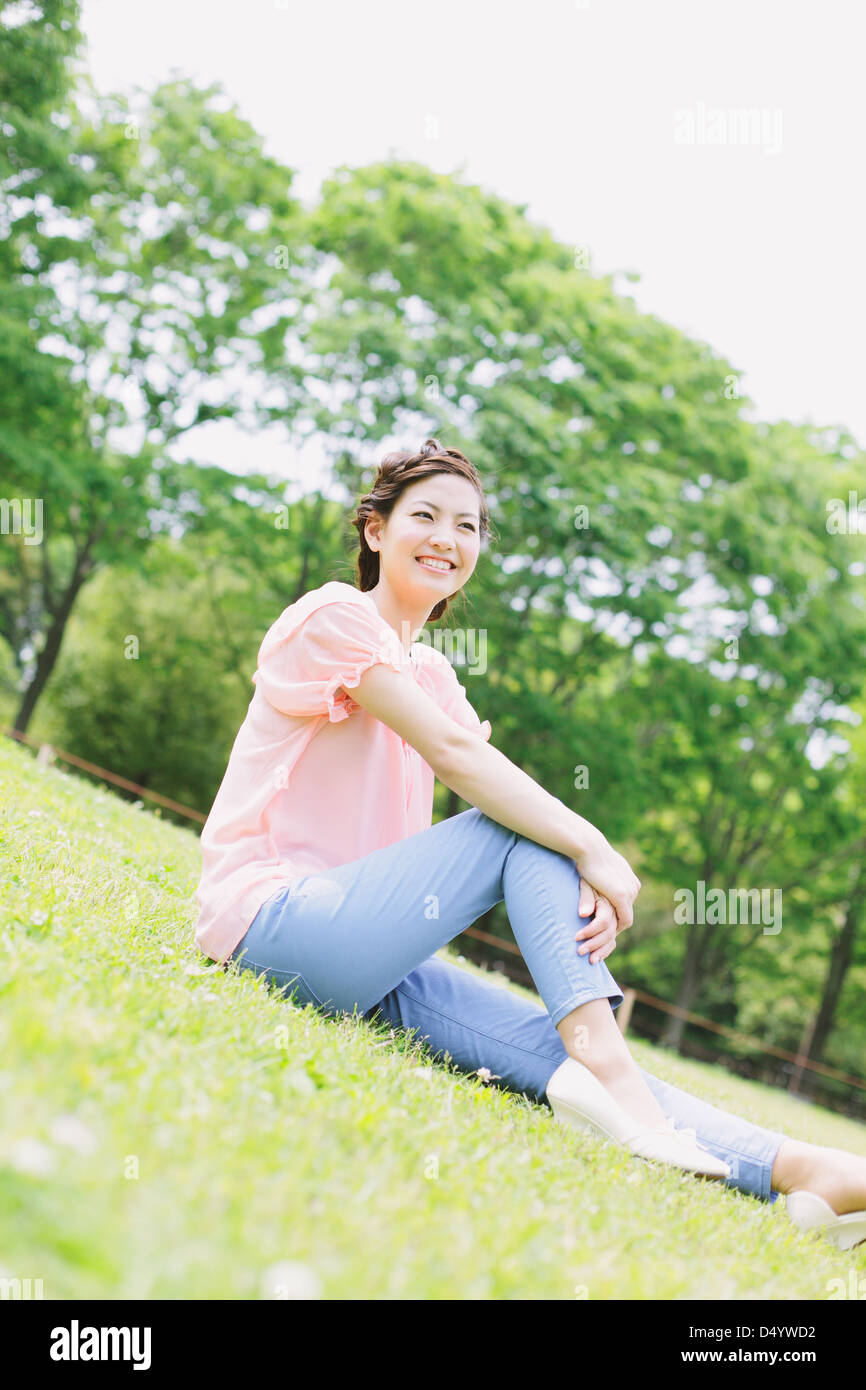 Japanese woman relaxing in a meadow Stock Photo - Alamy