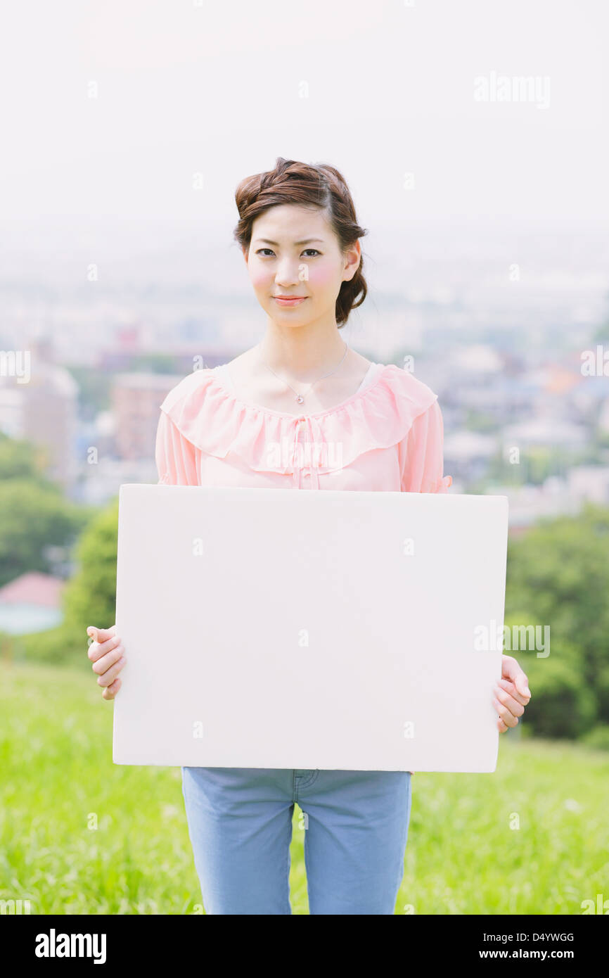 Japanese woman with a whiteboard looking at camera Stock Photo - Alamy