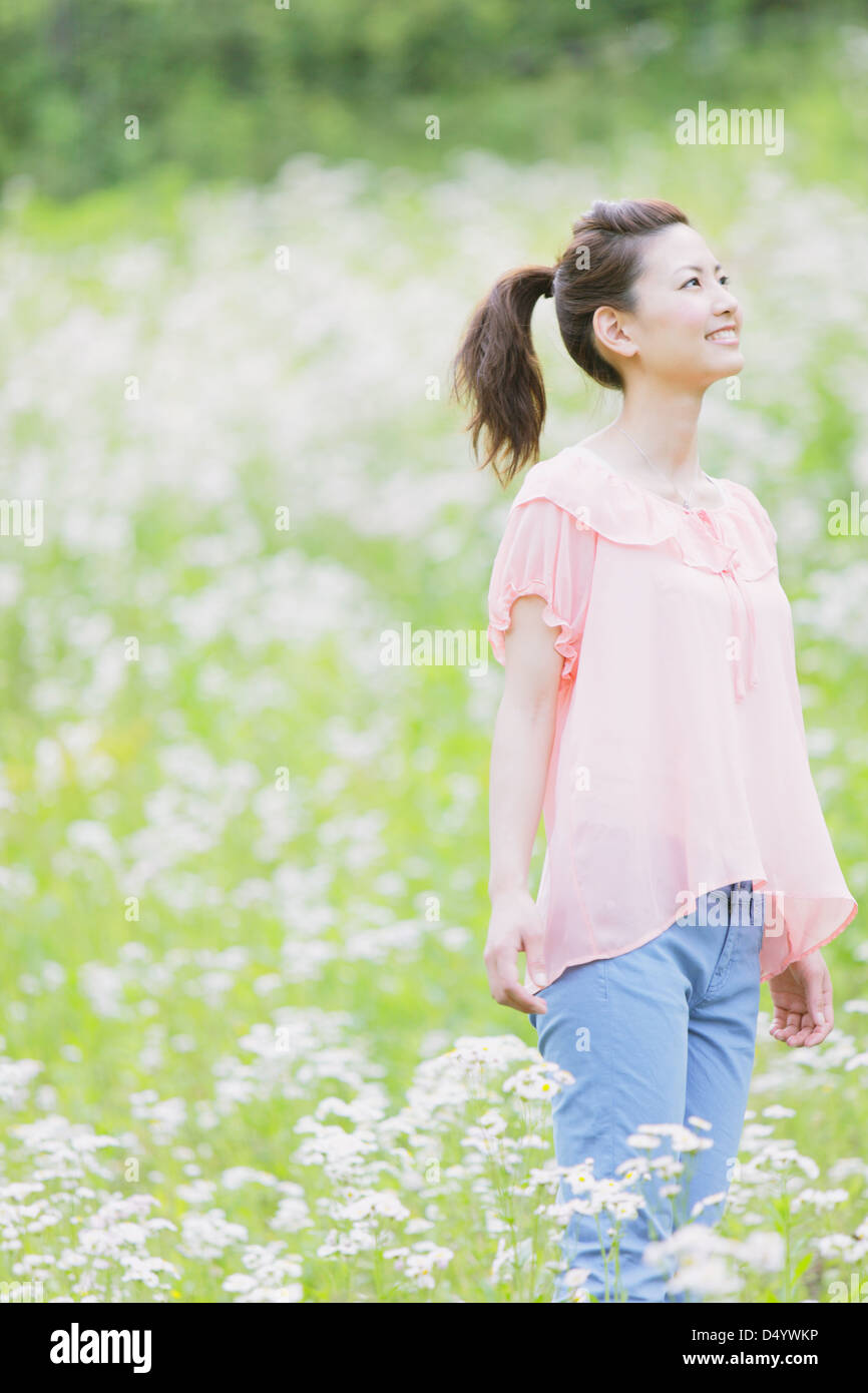 Japanese woman in a meadow smiling away Stock Photo - Alamy