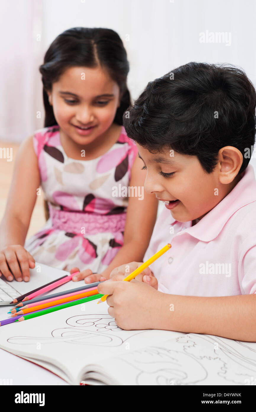 Children making drawings with colored pencils Stock Photo - Alamy