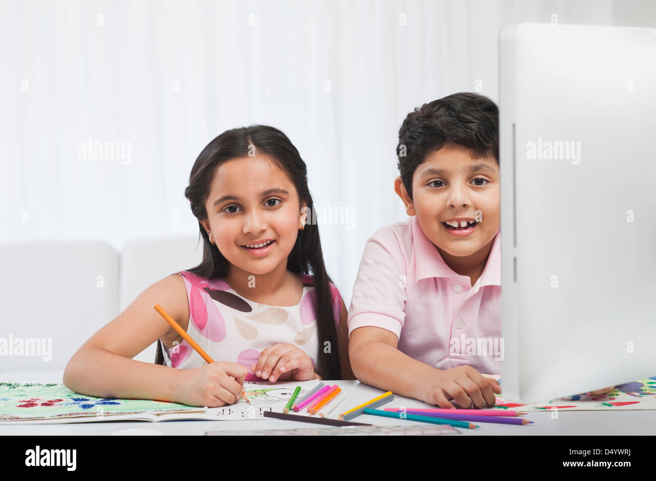 Children making drawings with colored pencils Stock Photo - Alamy