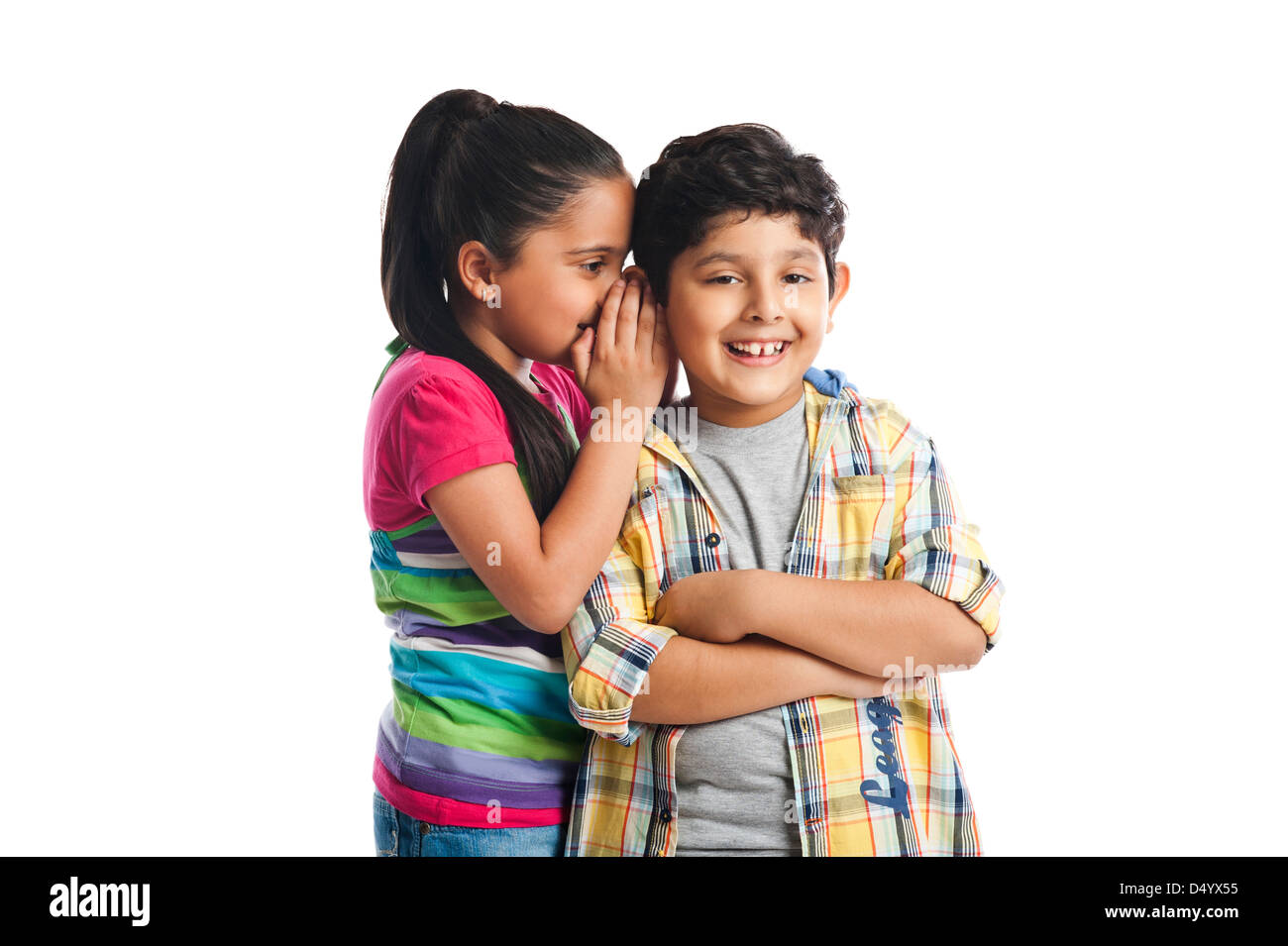 Girl whispering in her brothers ear Stock Photo - Alamy