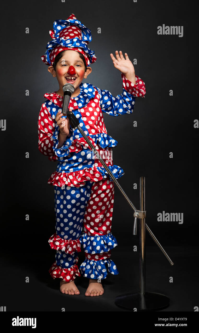 Boy imitating like a clown and singing Stock Photo - Alamy