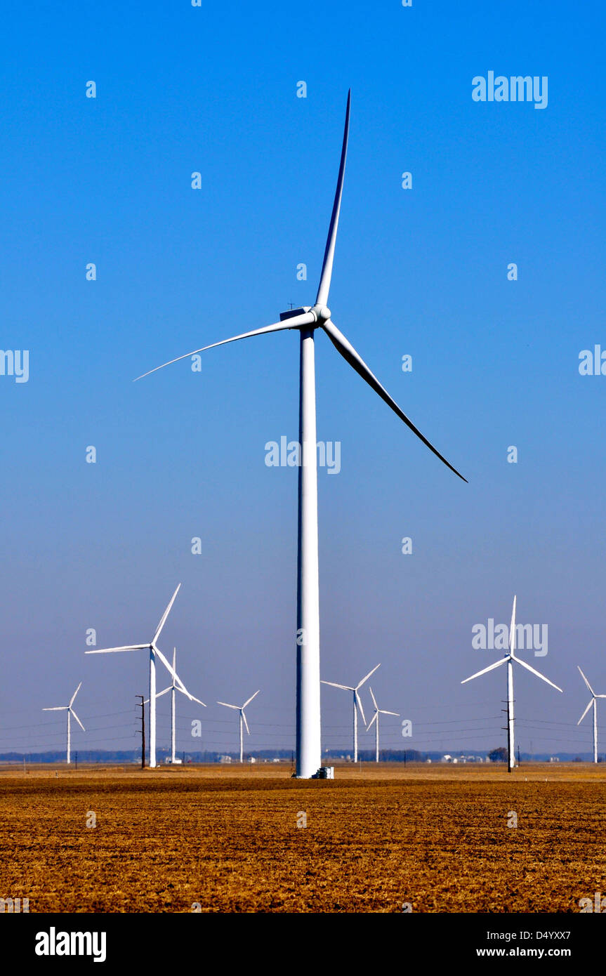 A windmill farm rotates over a Northwestern Indiana farm field Stock ...