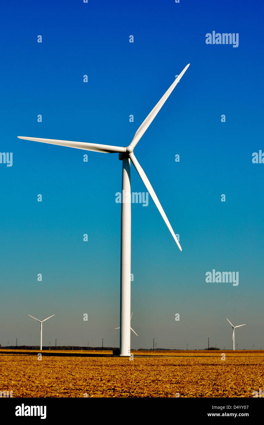 A windmill farm rotates over a Northwestern Indiana farm field Stock ...
