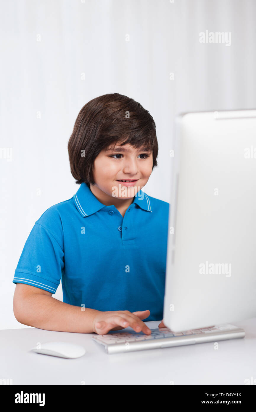 Boy using a desktop computer Stock Photo - Alamy