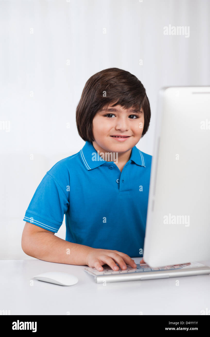 Boy using a desktop computer Stock Photo - Alamy