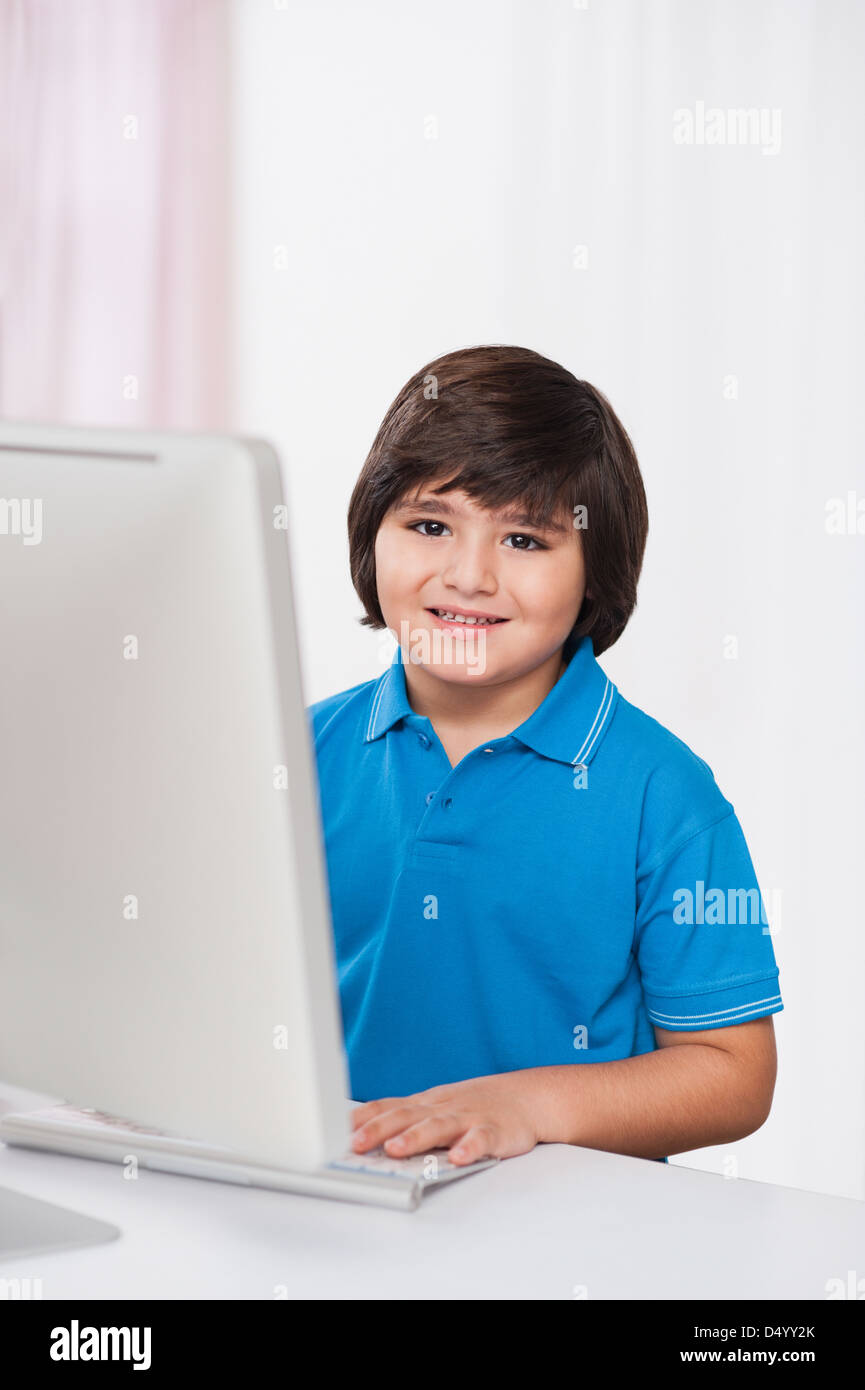 Boy using a desktop computer Stock Photo - Alamy