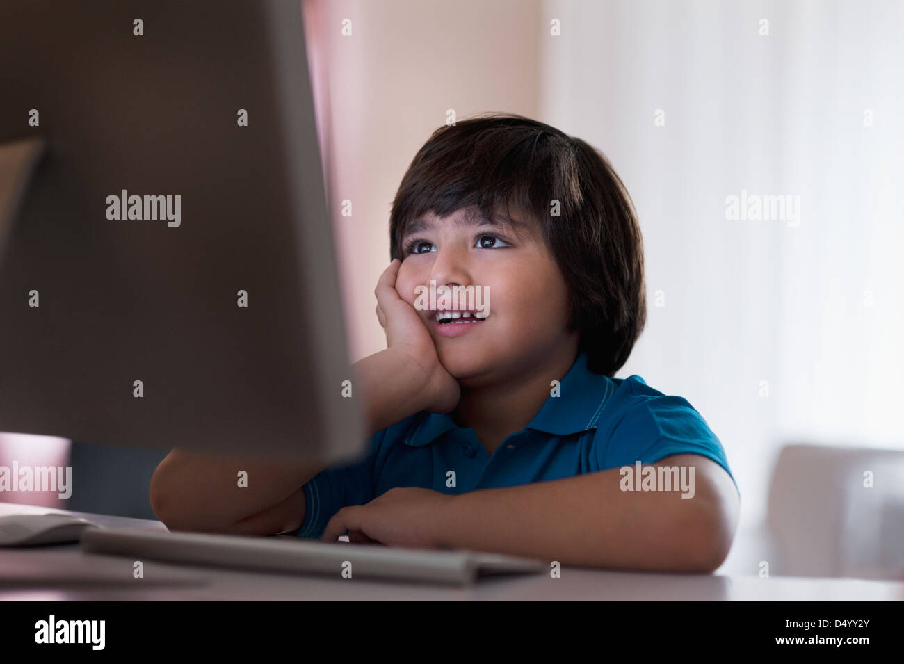Boy using a desktop computer Stock Photo - Alamy
