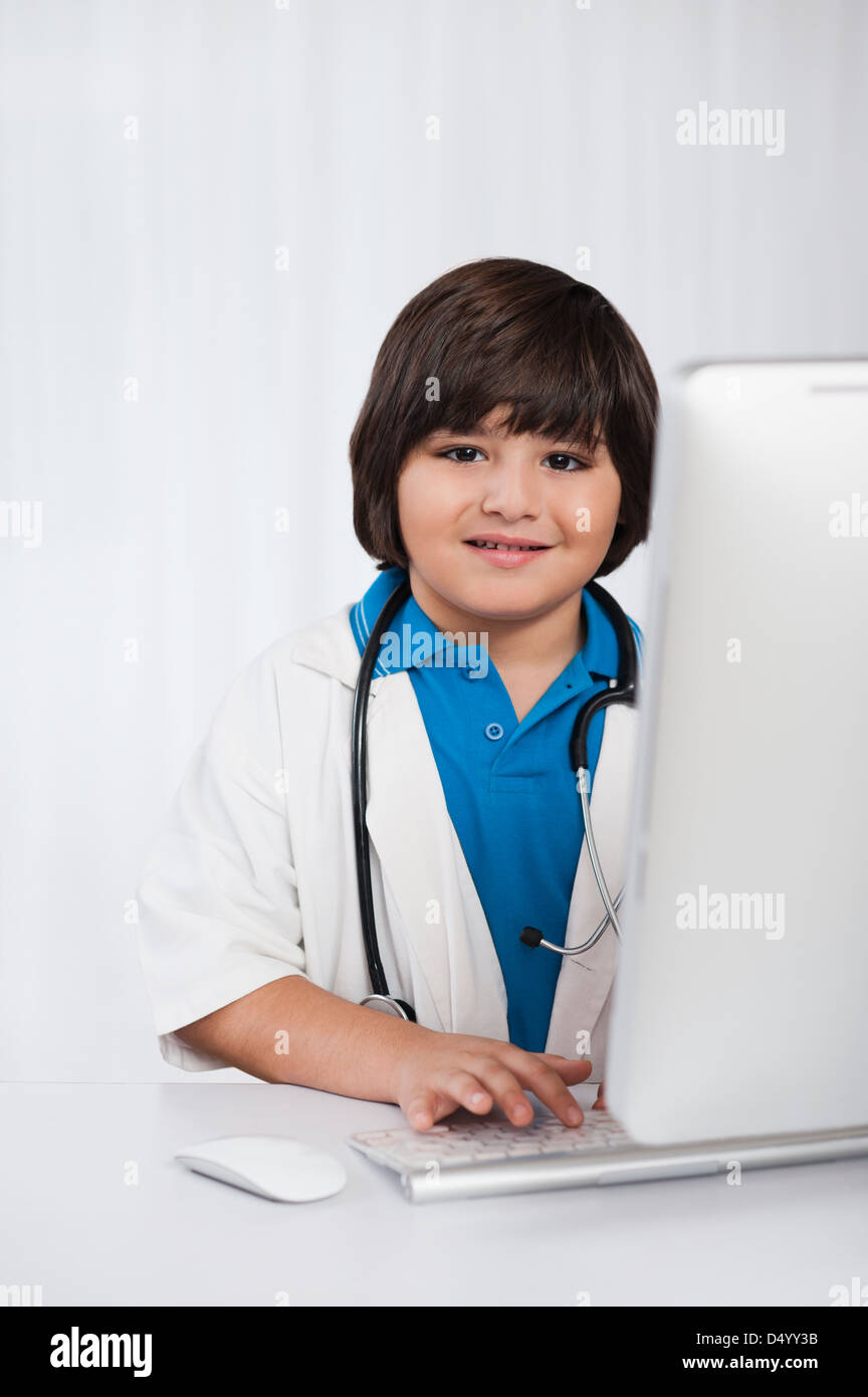 Smiling child with doctor using a stethoscope. indian hi-res stock ...