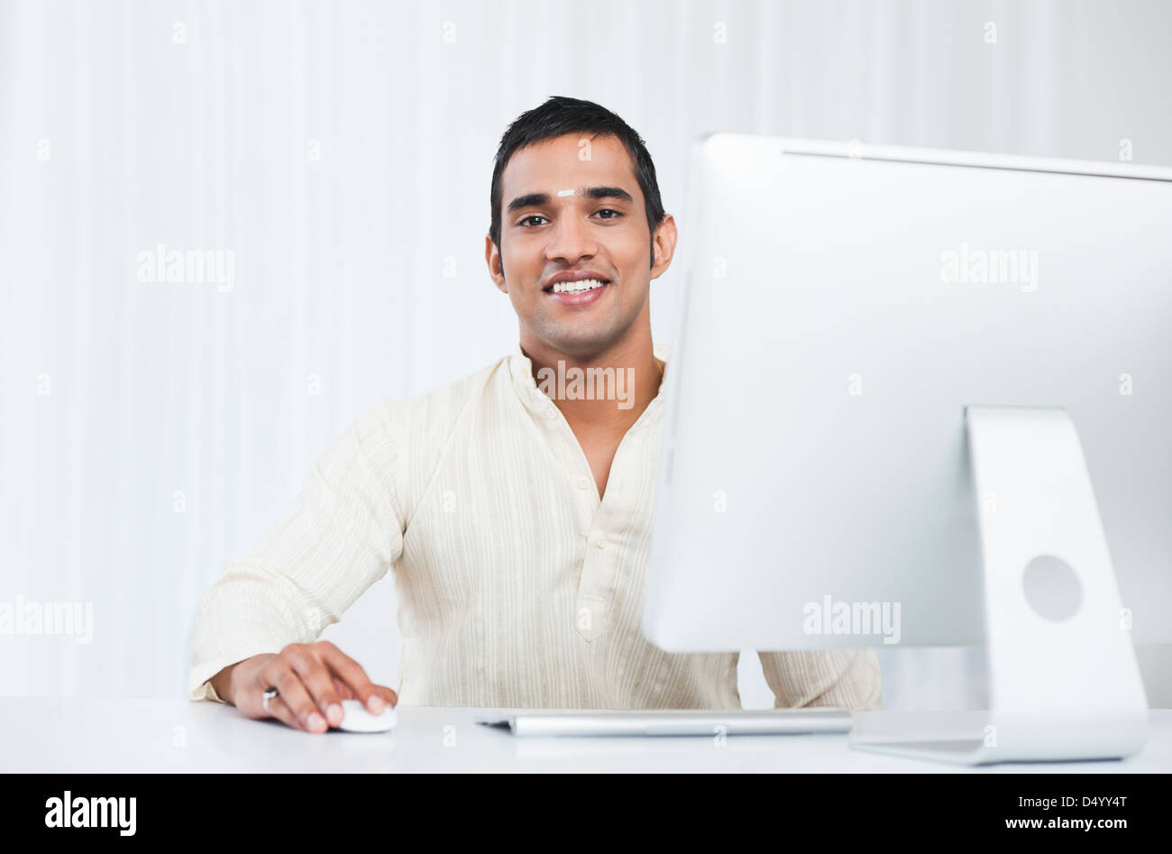 South Indian man using a desktop computer Stock Photo - Alamy