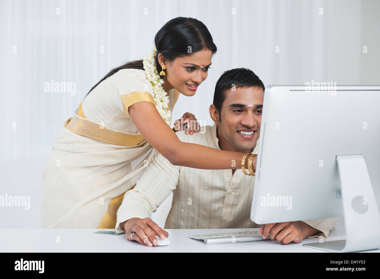 South Indian couple using a desktop computer Stock Photo - Alamy