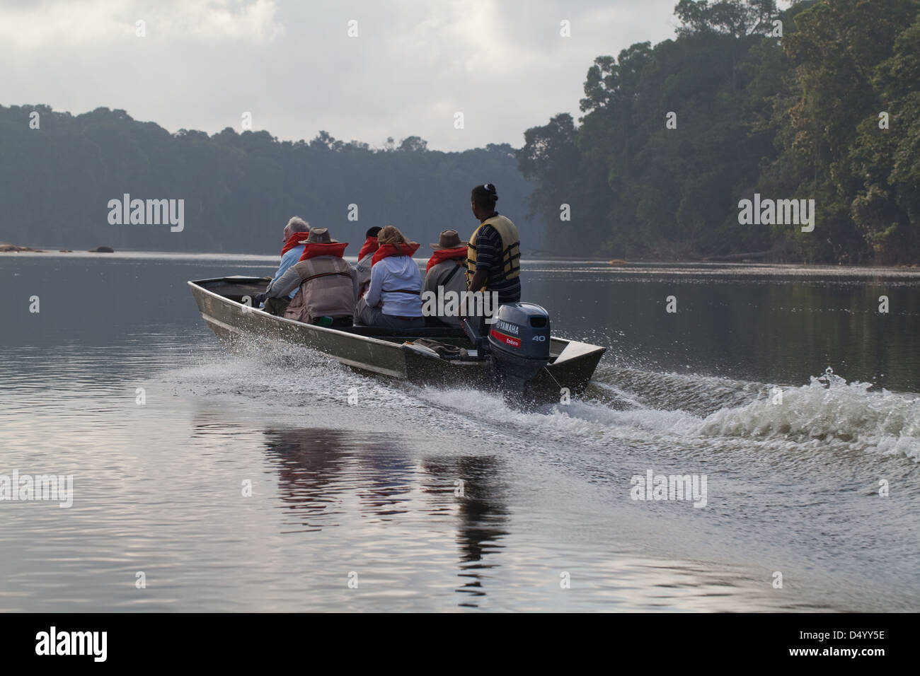 Eco-tourists on an evening motor boat run on the Essequibo River ...